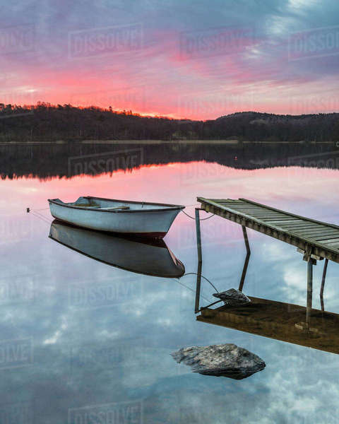 Rowboat moored at jetty, sunset - Stock Photo - Dissolve