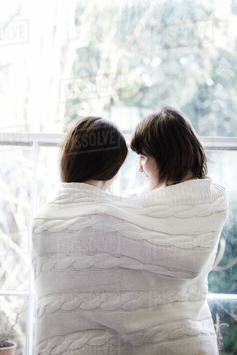 Couple wrapped in blanket - Royalty-free Stock Photo | Dissolve