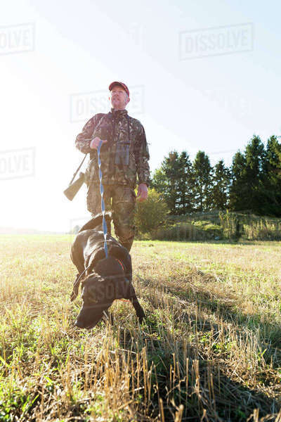 Man hunting with dog - Royalty-free Stock Photo | Dissolve