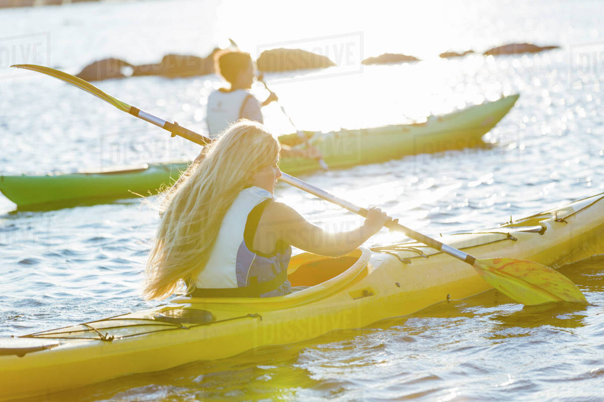 Women kayaking at evening - Stock Photo - Dissolve
