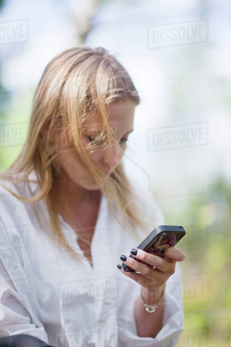 Young woman with cell phone - Royalty-free Stock Photo | Dissolve