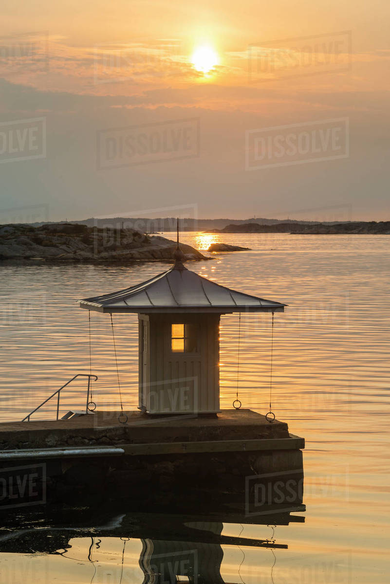 Built structure on jetty at sunset - Royalty-free Stock Photo | Dissolve
