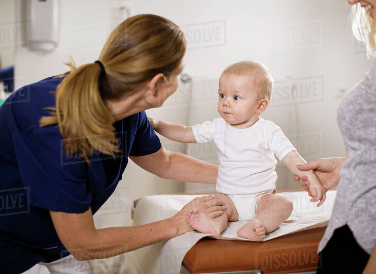 Doctor checking baby - Royalty-free Stock Photo | Dissolve