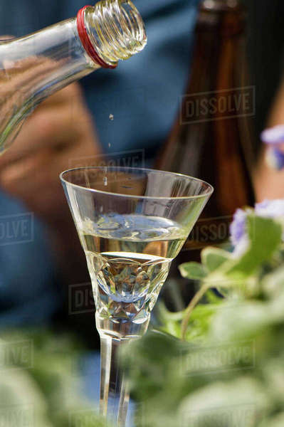 Pouring alcohol into shot glass - Royalty-free Stock Photo | Dissolve