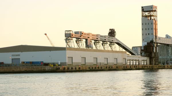 A large freighter dock at an ocean harbor for unloading and loading ...