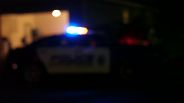 Red and blue flashing police lights and emergency vehicles at a crime ...