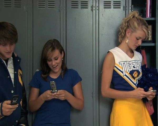 Panning shot of high school students on cell phones - Stock Video ...