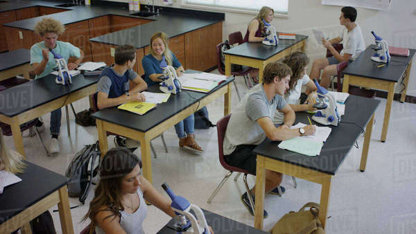 High angle view of students working together at scientific experiments ...