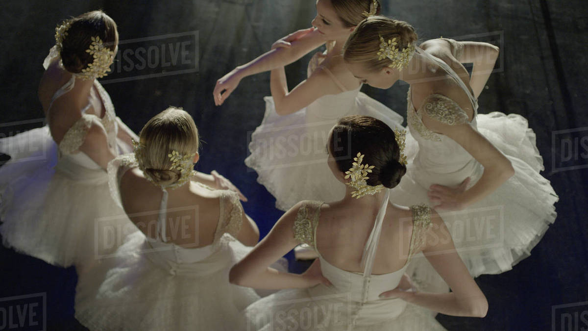 Overhead view of serious ballet dancers in costume standing backstage ...