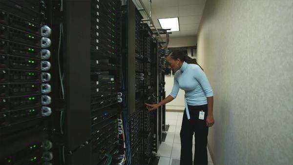 Woman in a server room - Stock Video Footage - Dissolve