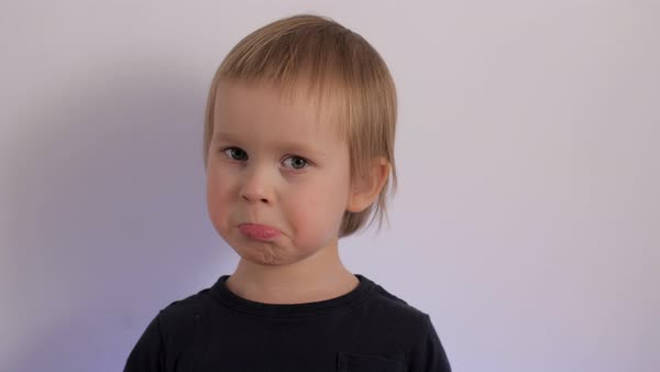 Portrait of focused upset cute little baby talking having negative ...
