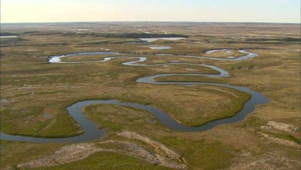 Tundra with snaking river. A expansive tundra witha river snaking ...