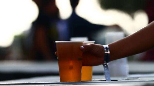 Hands Grabbing Beer. Three beers are lined up in a row. Alternatively ...