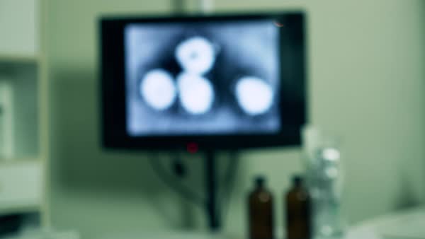 Handheld scene moves past laboratory test tubes and other paraphernalia ...