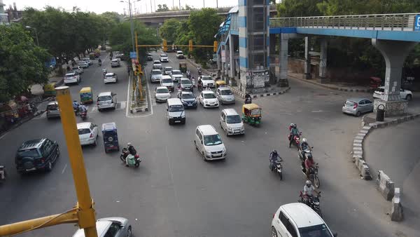 Top view looking down at busy road intersection with vehicular traffic ...