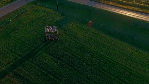 An epic, circular sweeping shot of a man working on his laptop outdoors ...