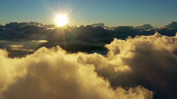 Flying above the clouds. Aerial view of clouds and morning sun ...