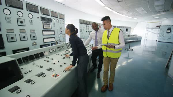 Team of engineers working in power station control room - Stock Video ...
