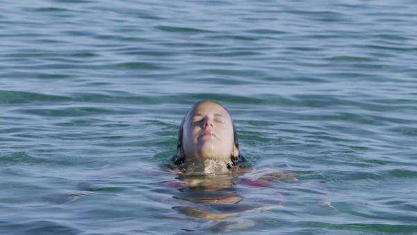 Beautiful woman emerging from the water at the beach - HD Royalty-free ...