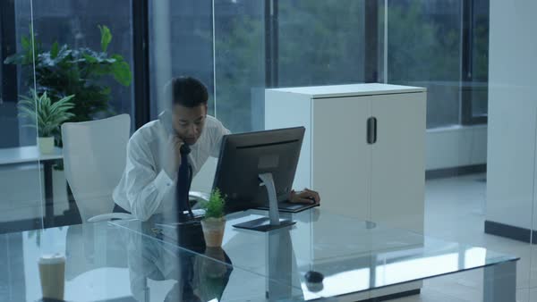 International business team looking at world map graphic on video wall ...