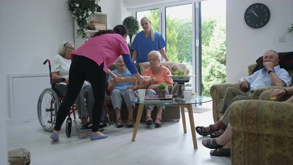 Caring staff in retirement home taking care of elderly residents and ...