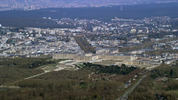 Aerial view above the palace of Versailles with landscaped gardens and ...