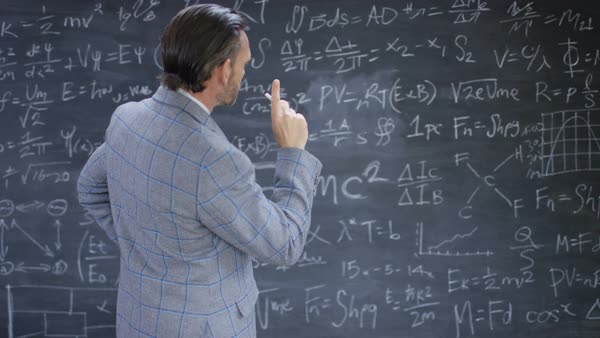 Portrait smiling academic man in classroom studying math formulas on ...