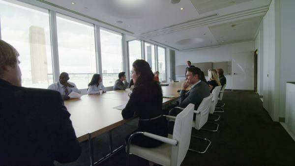 Corporate business team in boardroom meeting in London city office ...
