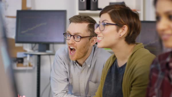 Young computer experts working in office with lots of computers. Could ...
