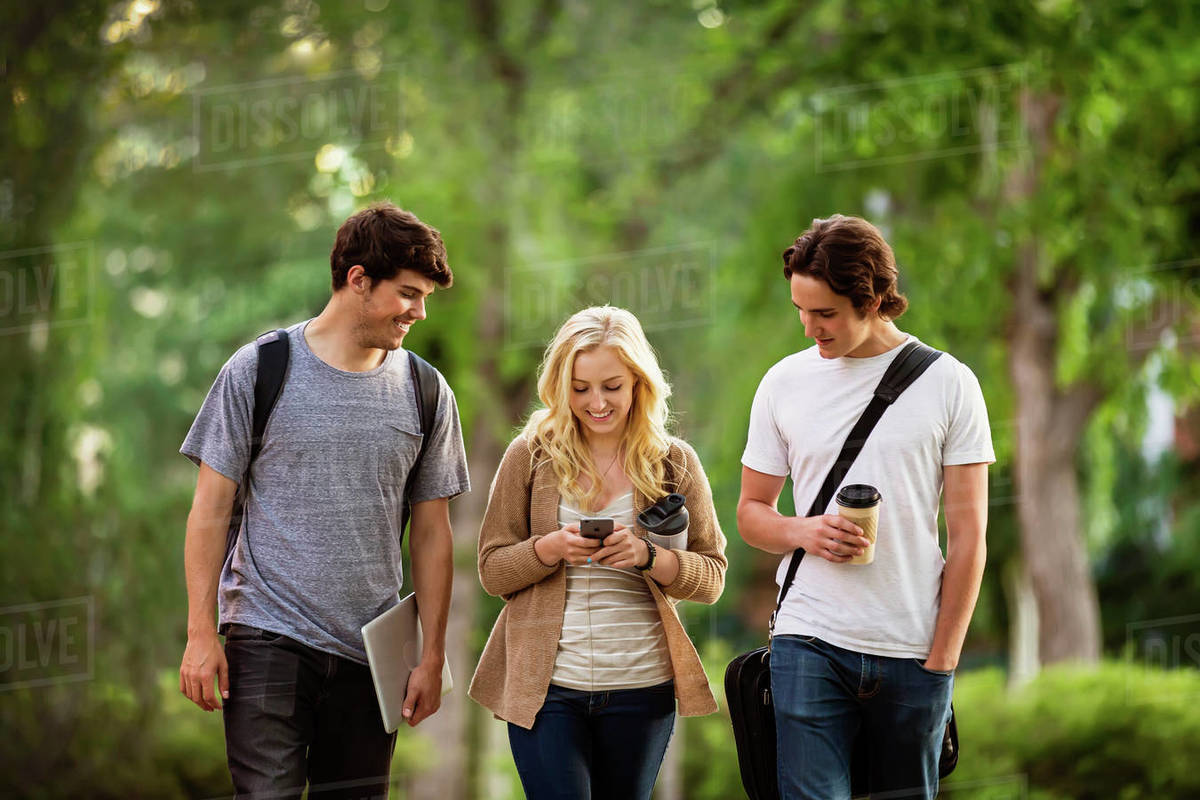 Three friends walking and talking on the university campus; Edmonton ...