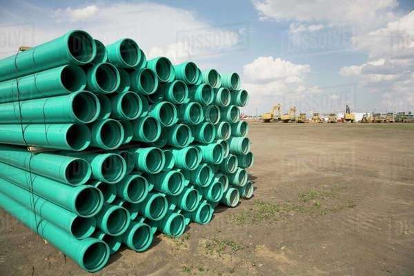 Stack Of Water Pipes For New Construction Site - Stock Photo - Dissolve