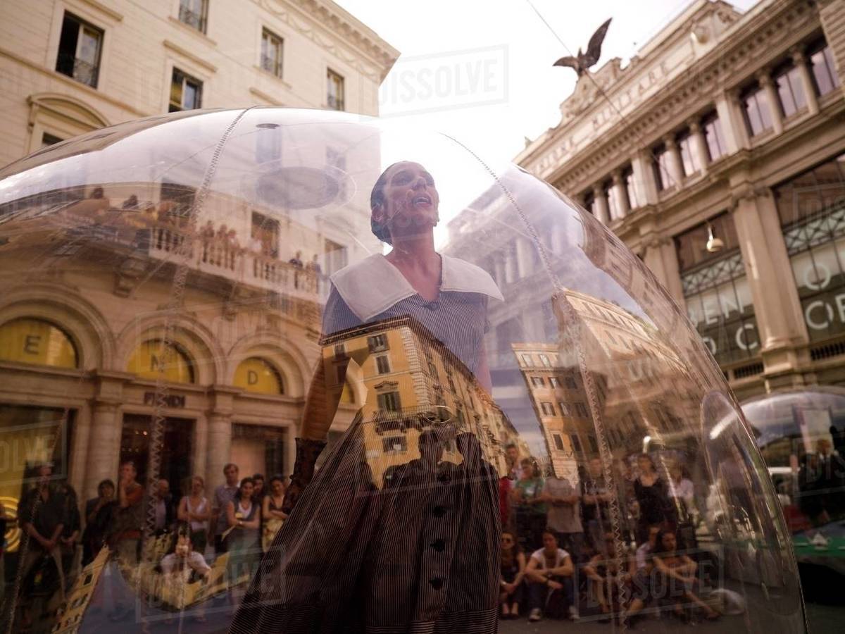 Woman Standing Inside Transparent Glass Globe And Crowd Watching Her ...