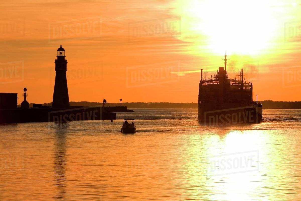 Buffalo Lighthouse And Cement Carrier In Buffalo Port At Sunset - Stock ...