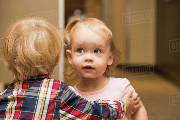 Two toddlers hugging in hallway at family dental clinic; Edmonton ...