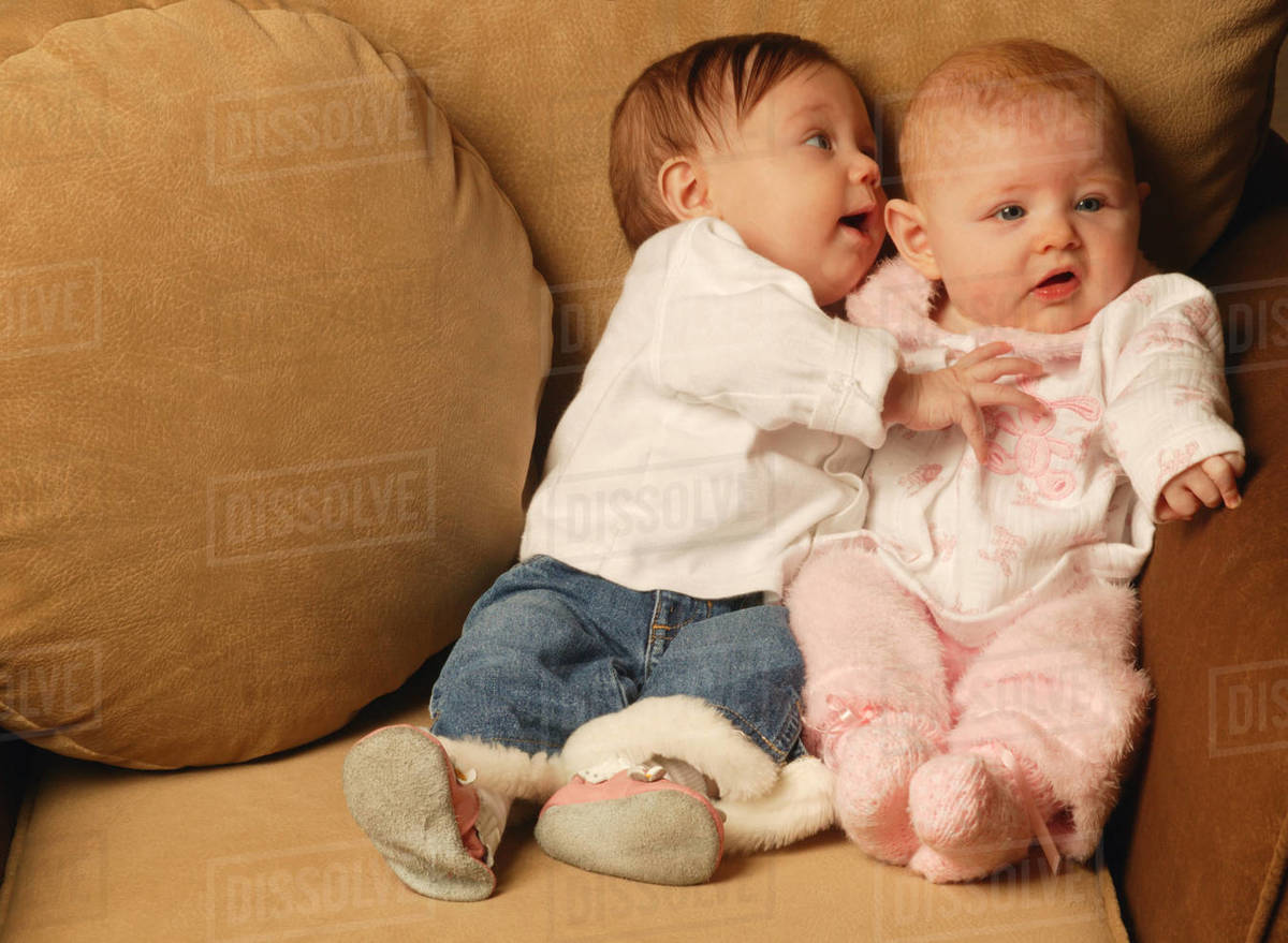 Two Babies Sitting Together - Stock Photo - Dissolve