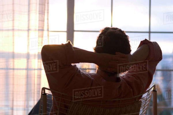 Person Relaxing By Window - Stock Photo - Dissolve