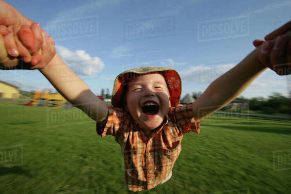 Child Being Swung Around - Stock Photo - Dissolve