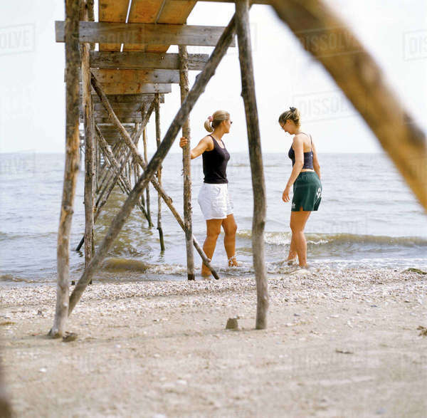 Women Under Pier, Lake Winnipeg, Manitoba - Stock Photo - Dissolve