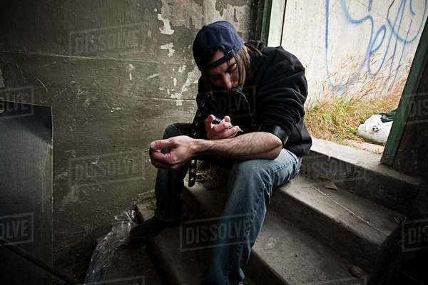 Man Injecting Drugs - Stock Photo - Dissolve