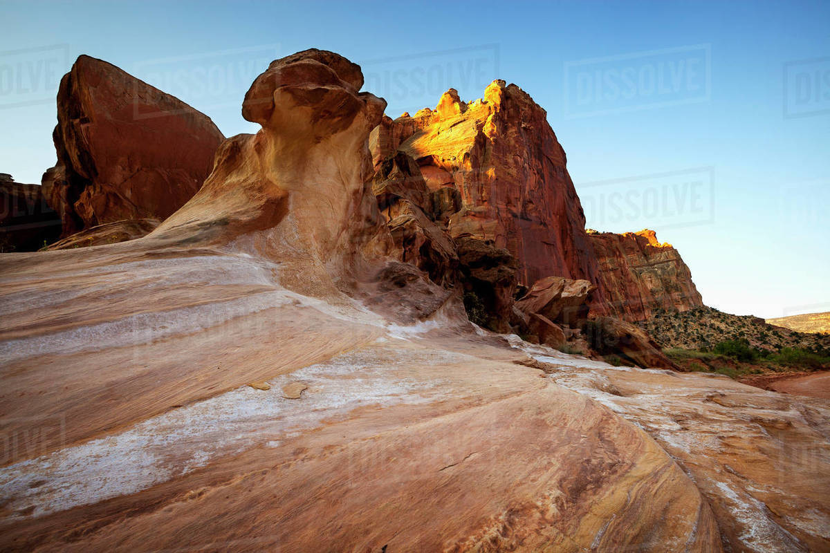 Smooth, Worn Rock Formations In The Foreground Sweeping Up To Tall ...