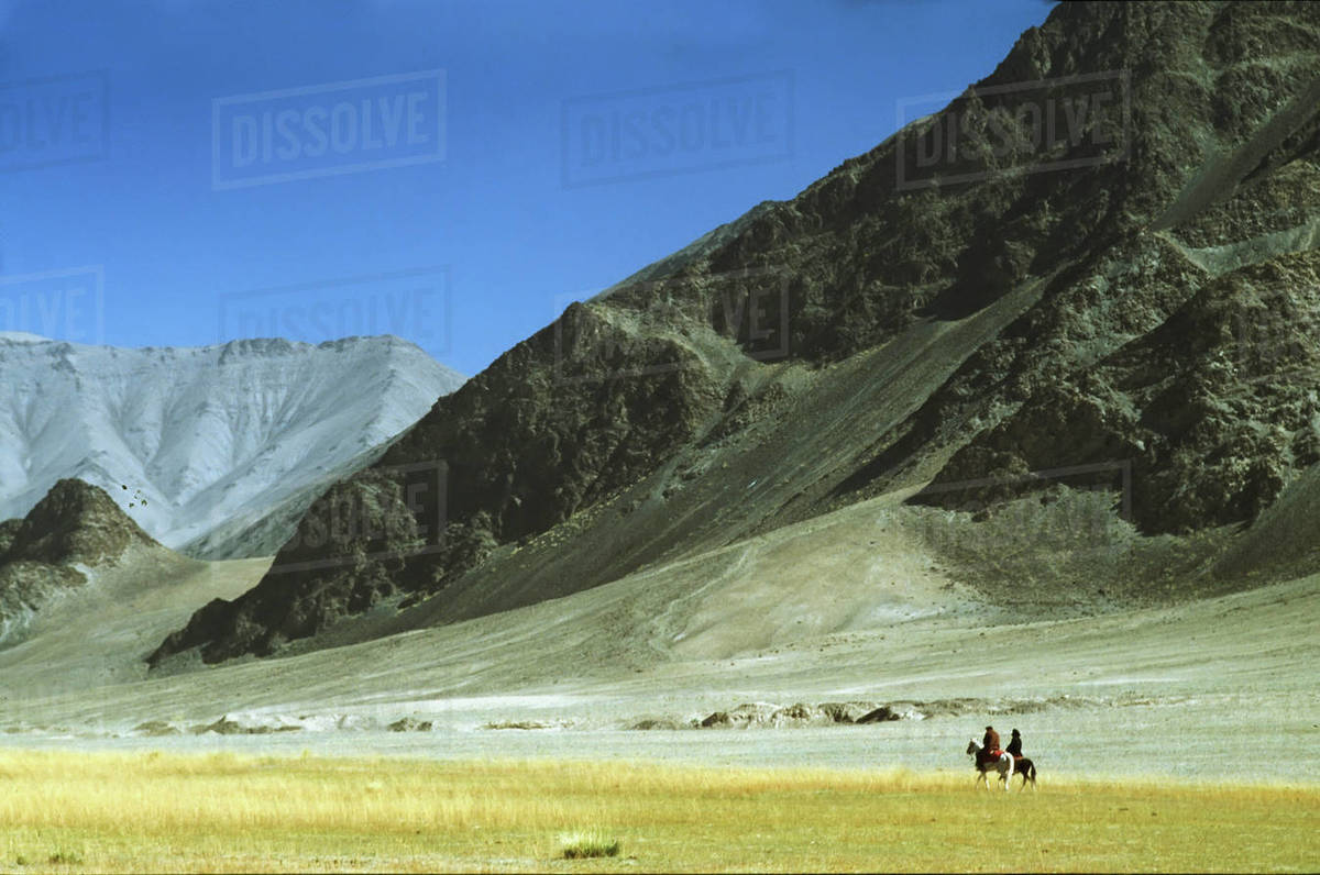 Local Horsemen In Pamirs Mountains,Xinjiang,China - Stock Photo - Dissolve