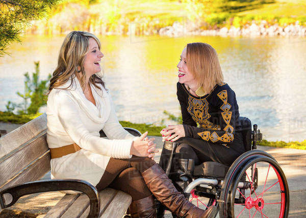 Young paraplegic woman and her friend spending quality time together in ...