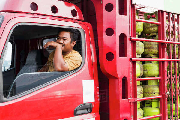 Truck Driver Smoking A Cigarette In A Truck With Gas Containers On ...