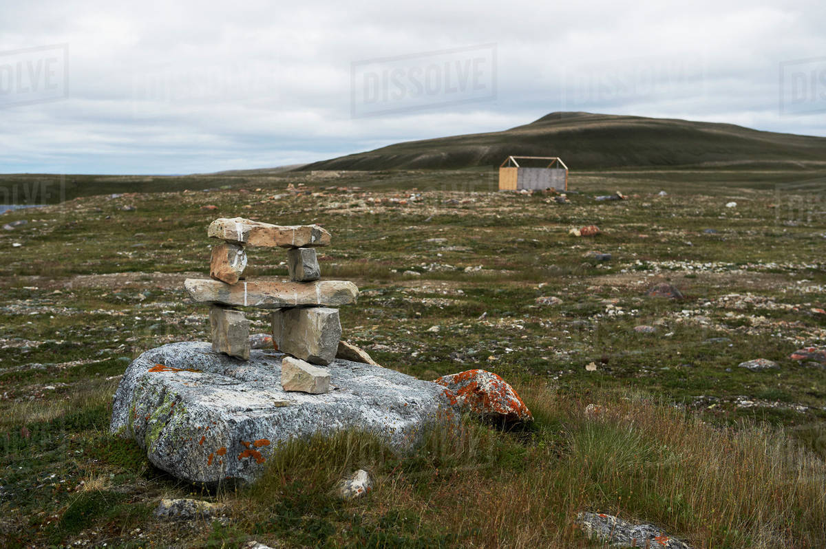 Mount Pelly and inukshuk on the tundra; Cambridge Bay, Nunavut, Canada ...