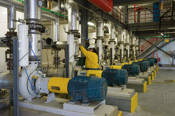 Agriculture - Ethanol production plant. A technician prepares to take ...