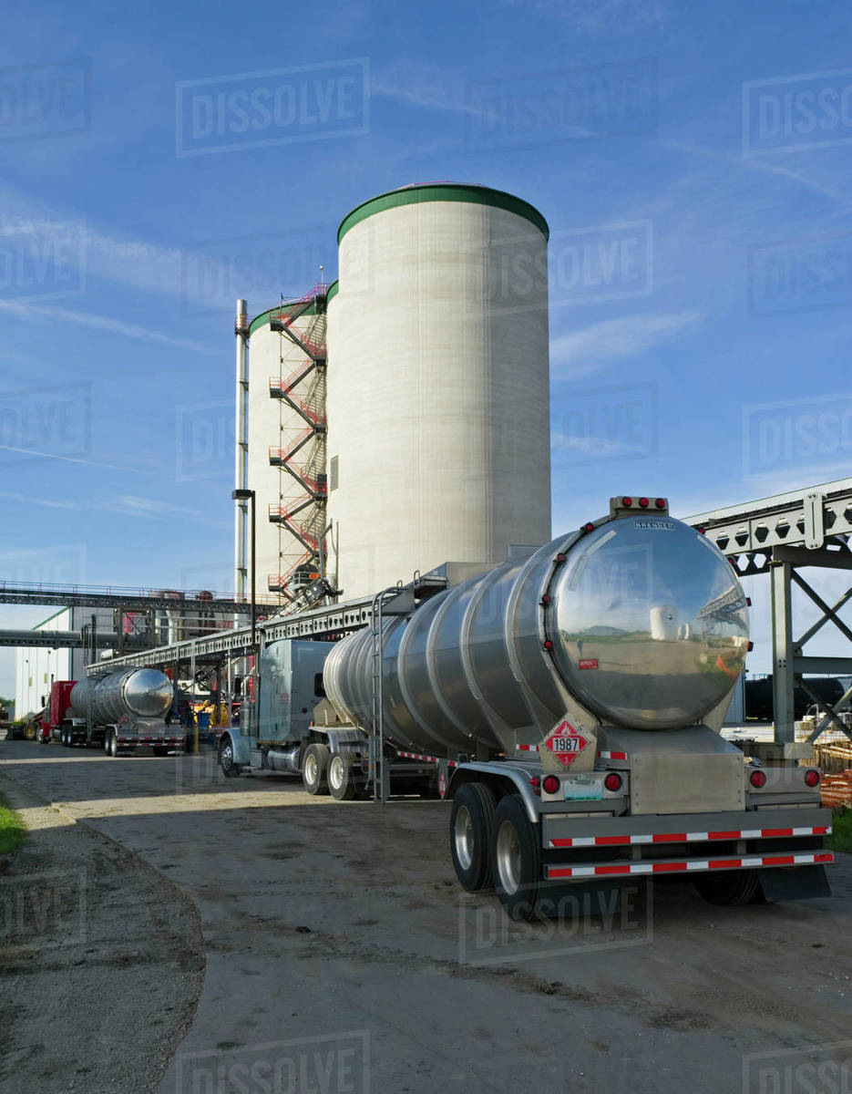 Agriculture - Ethanol production plant. Tank trucks line up to be ...