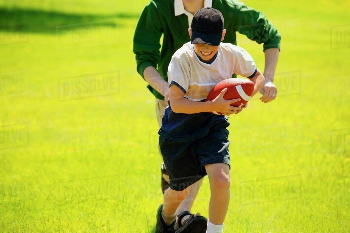 Playing Football - Stock Photo - Dissolve
