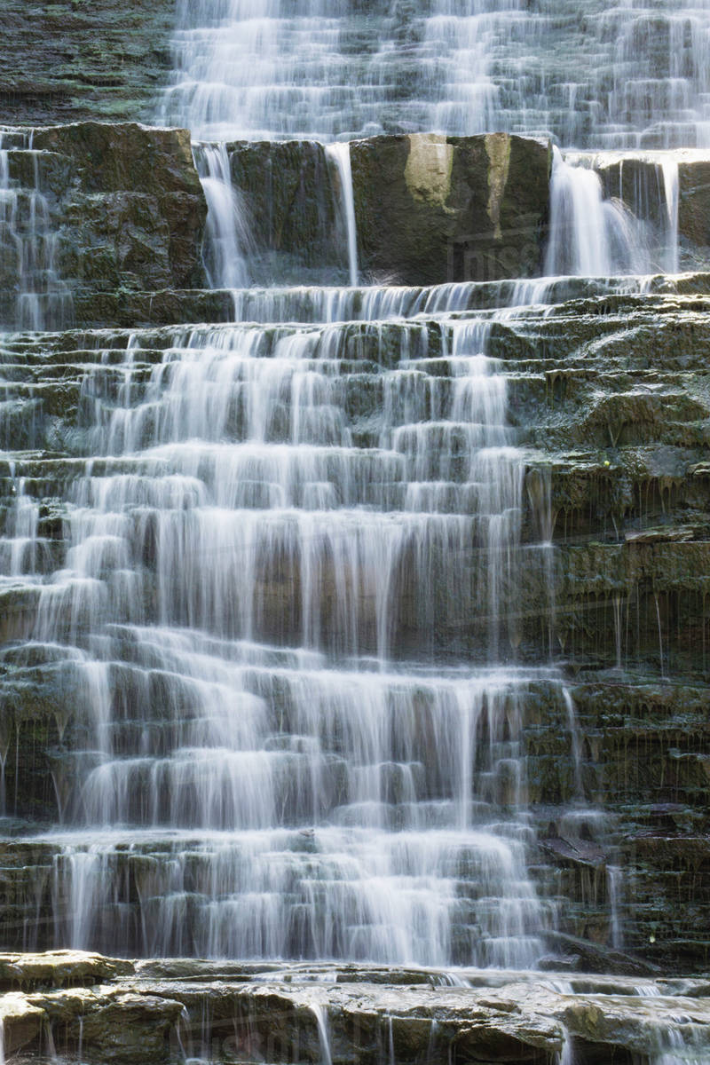 Waterfalls with water flowing over steps of rock; Hamilton, Ontario ...