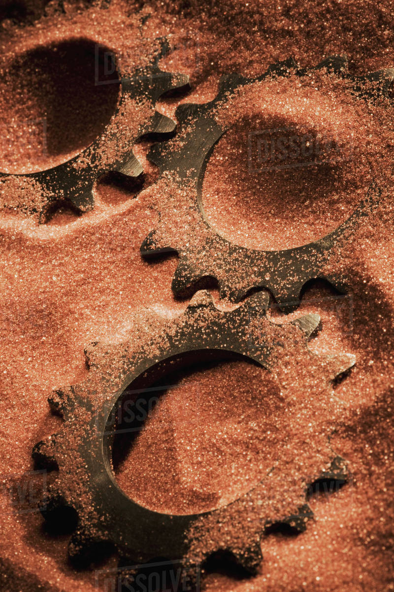 Gears covered in sand - Stock Photo - Dissolve
