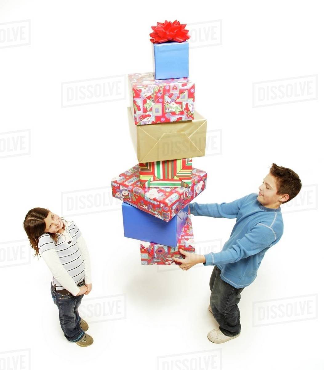 Boy Gives Stack Of Presents To Girl - Royalty-free Stock Photo | Dissolve